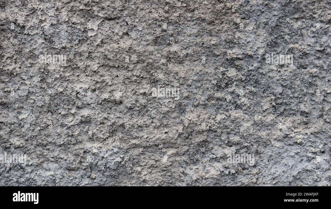 gray textured background with uneven surface of hardened concrete ...