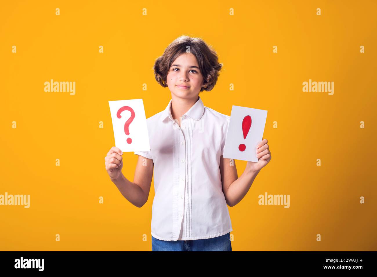 A portrain of kid girl holding cards with question mark and exclamation ...
