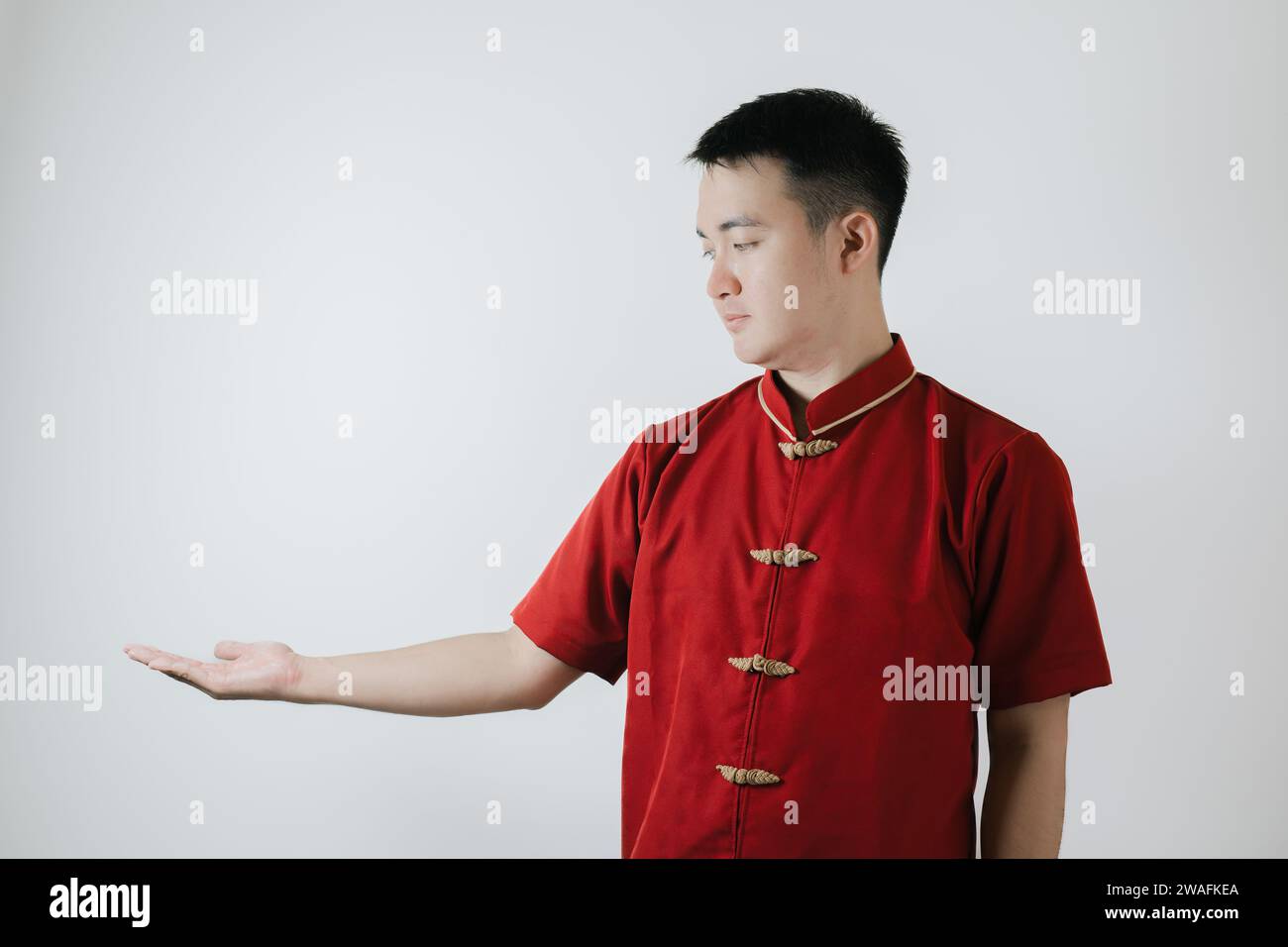 Asian man wearing Chinese traditional cloth called Cheongsam is open ...