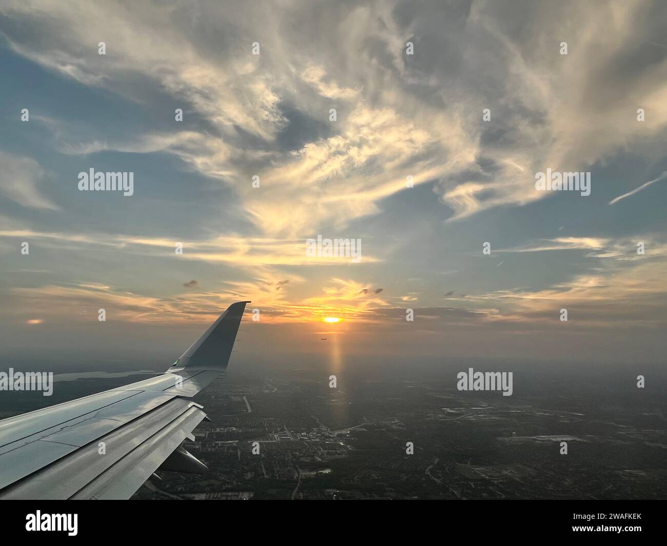 The wing of a commercial airline airplane while flying high in the sky ...