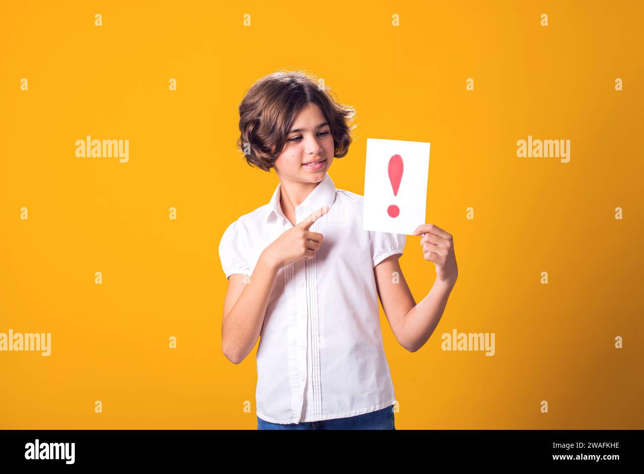A portrain of kid girl holding exclamation point card. Children, idea ...