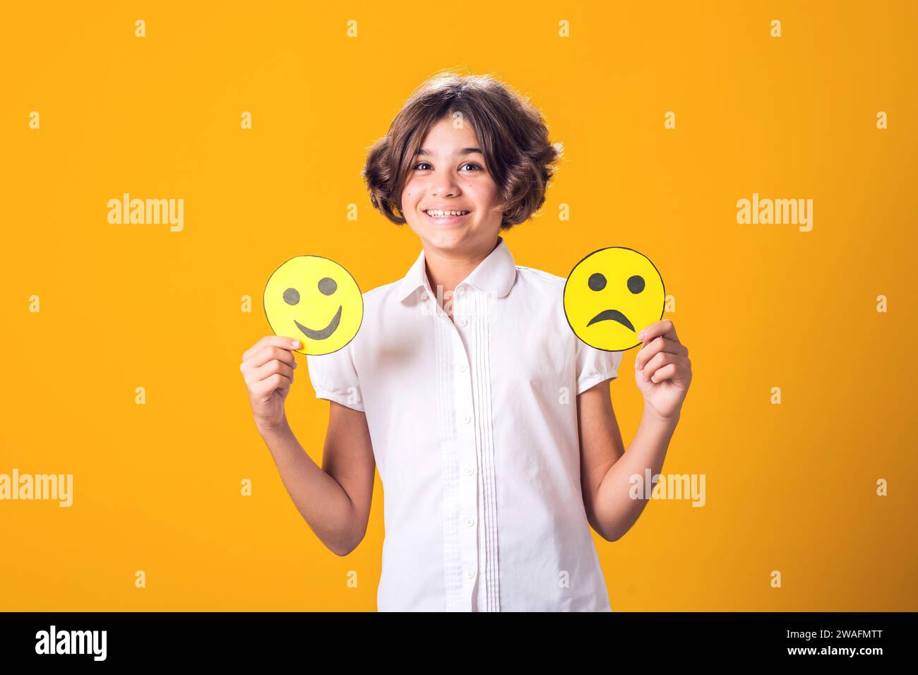 Girl holds sad and happy emoticons in hands. Mental health, psychology ...
