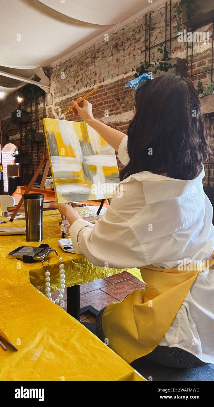 Woman paint brush canvas friends hi-res stock photography and images ...