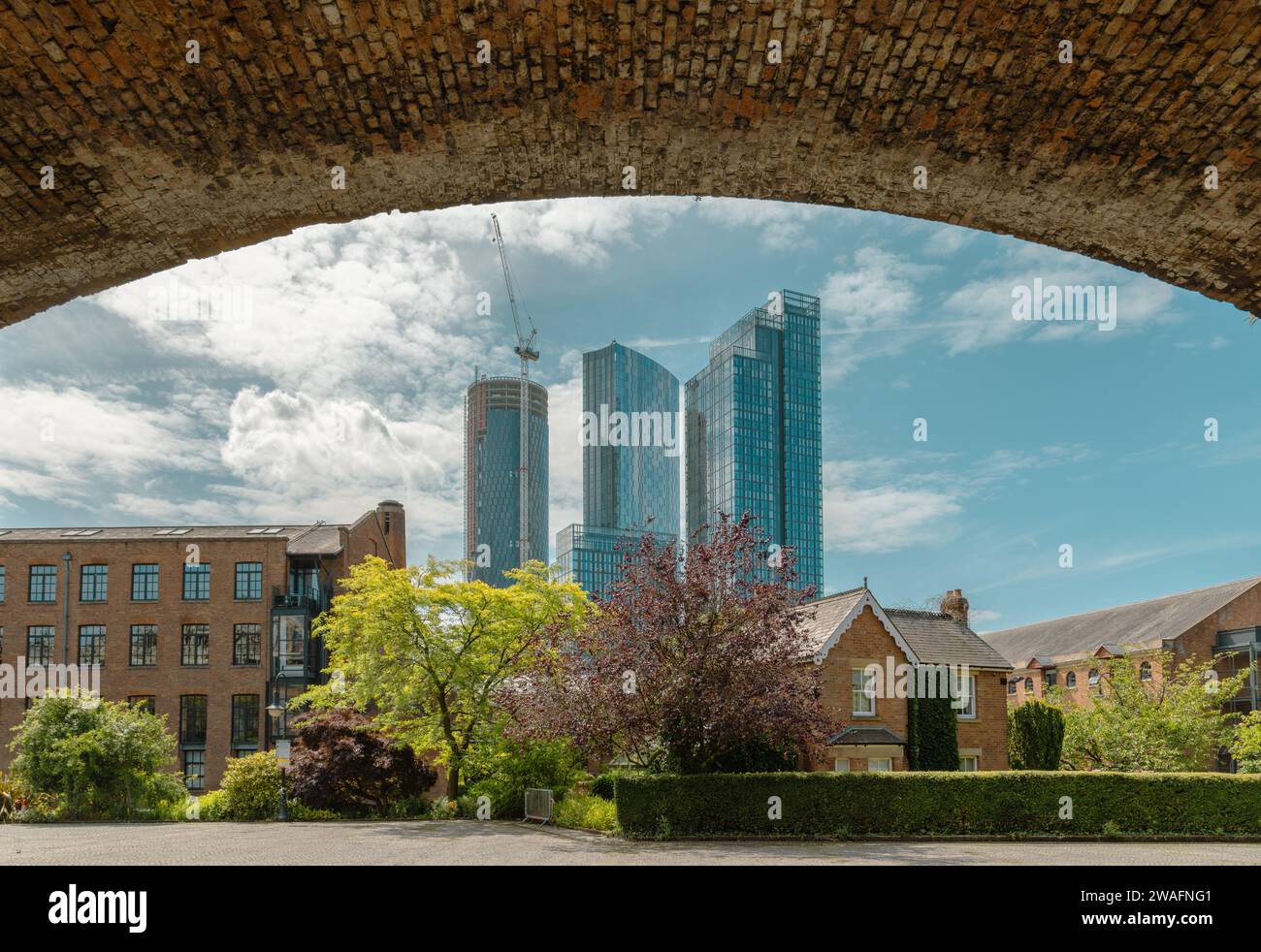 Framed by a railway bridge, the contemporary architecture of Manchester ...
