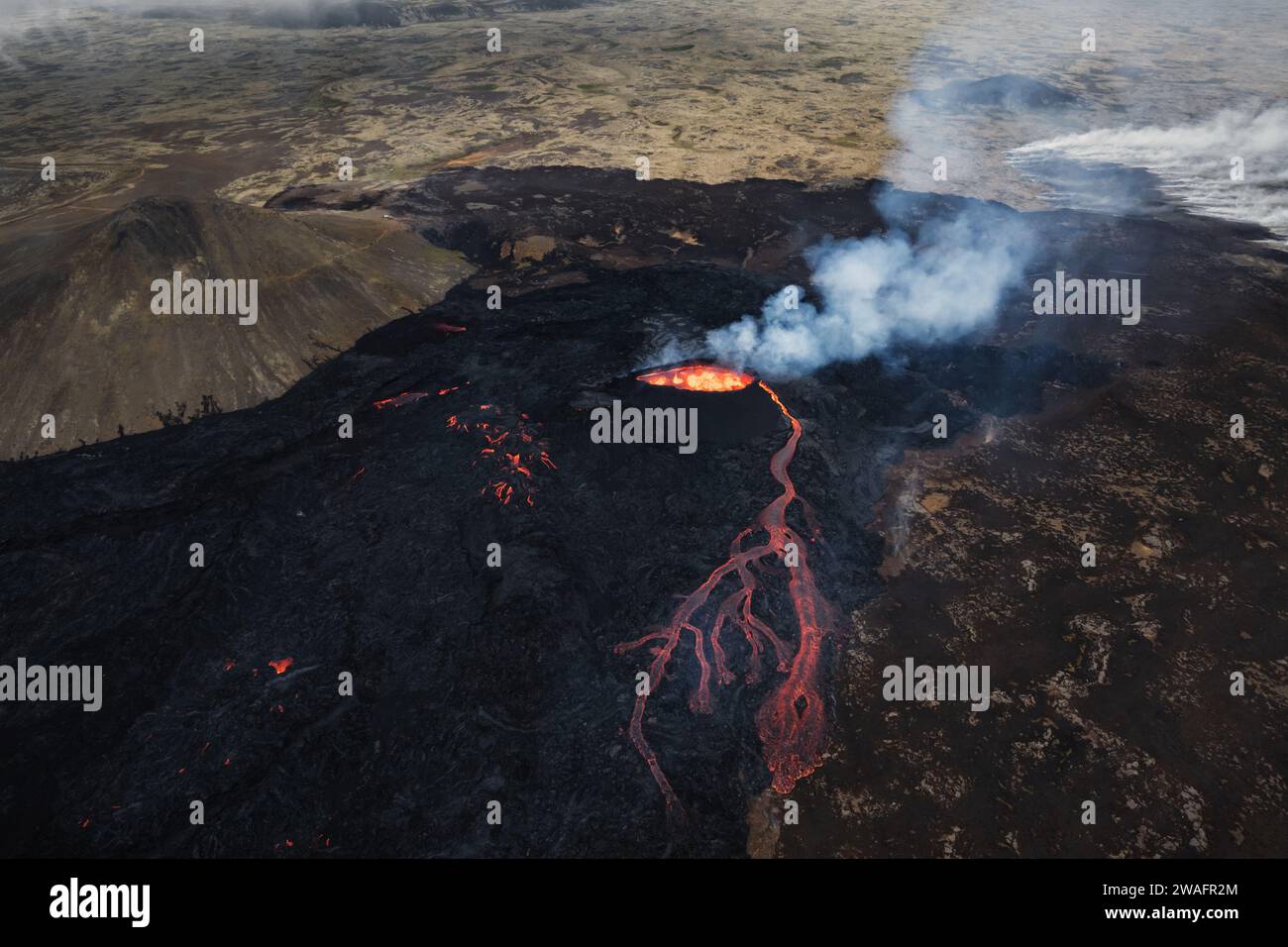 Volcano eruption in Iceland, summit crater, gas expulsion, and molten ...