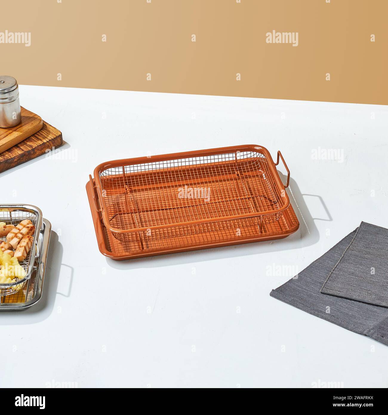 A brown stainless steel oil tray, with utensils surrounding it, on a ...