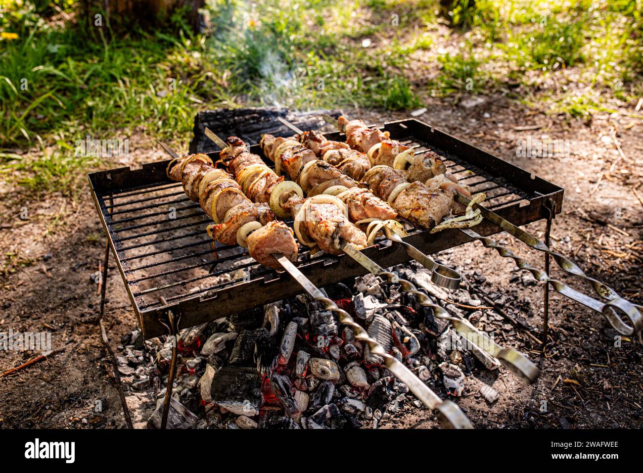 Turning half cooked meat pieces hi-res stock photography and images - Alamy