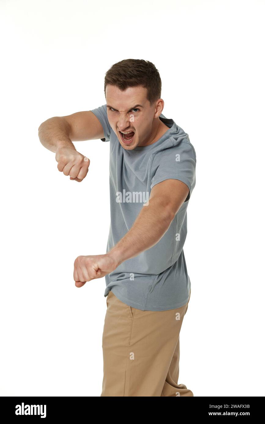 annoyed angry man fighting on white studio background Stock Photo - Alamy