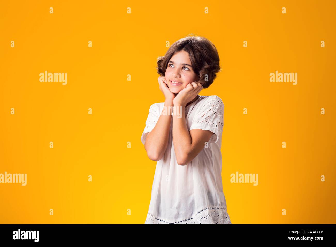Smiling kid girl over yellow background. Emotion concept Stock Photo ...