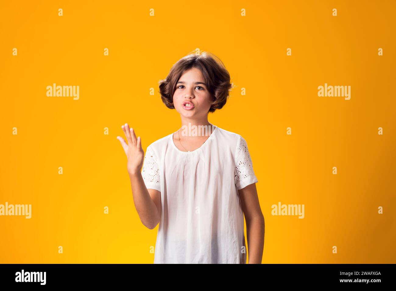 Indignant angry expressive confused kid girl over yellow background ...