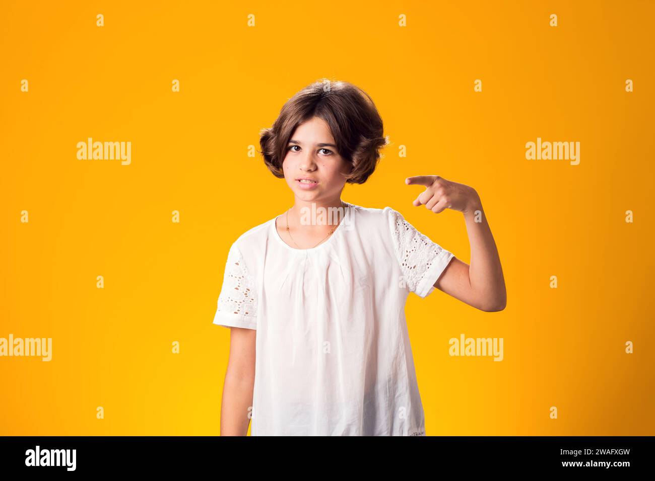 Kid girl pointing displeased and frustrated to the camera, angry and ...