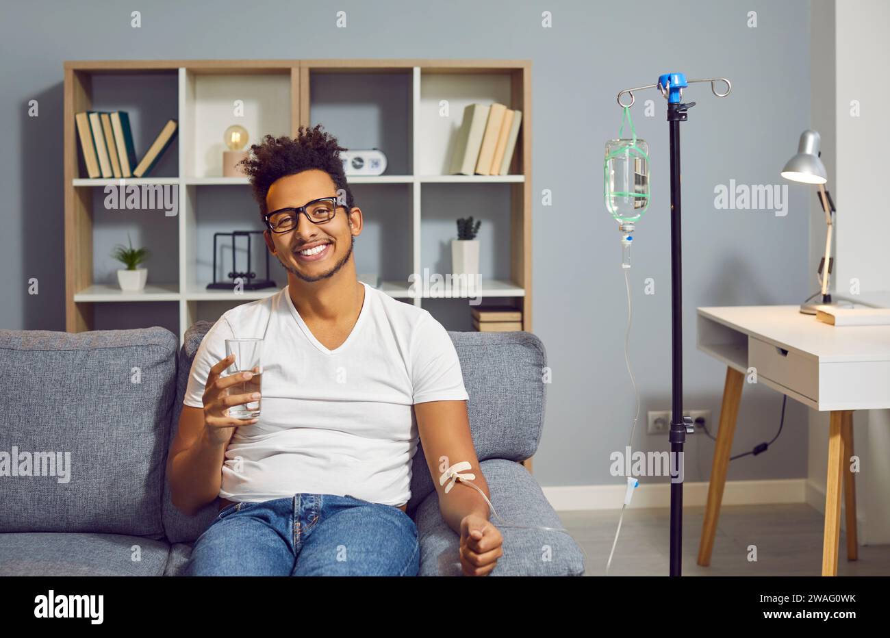 Young happy african american man receiving IV drip infusion and vitamin ...