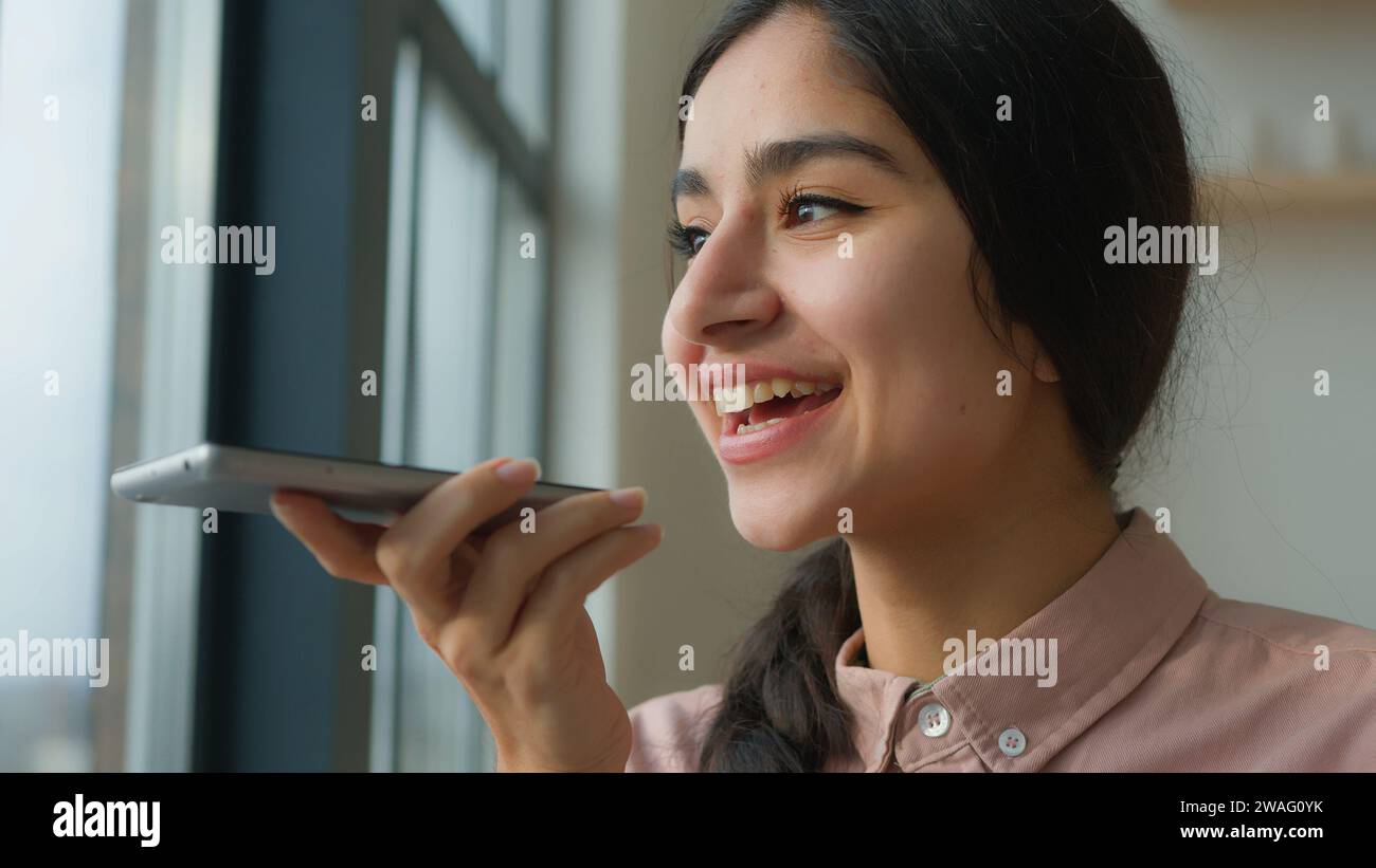 Close up Arabian woman record voice message on speaker phone talking ...