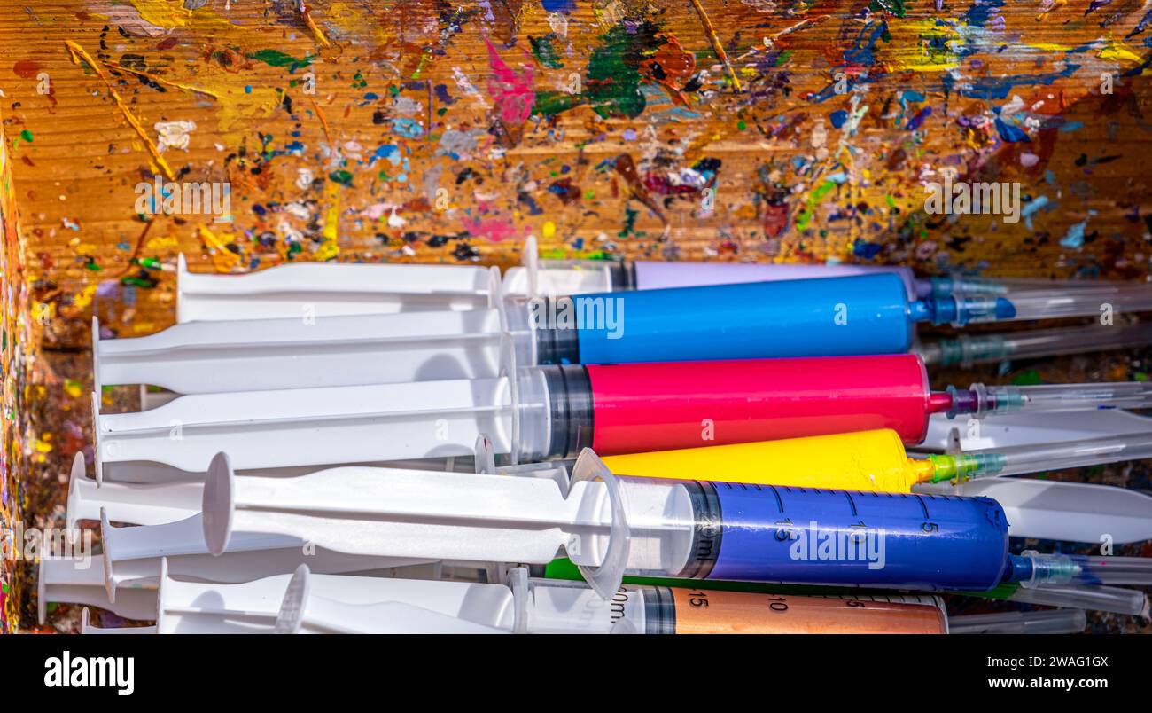 a bunch of Syringes with multi-colored liquid in the wooden box Stock ...