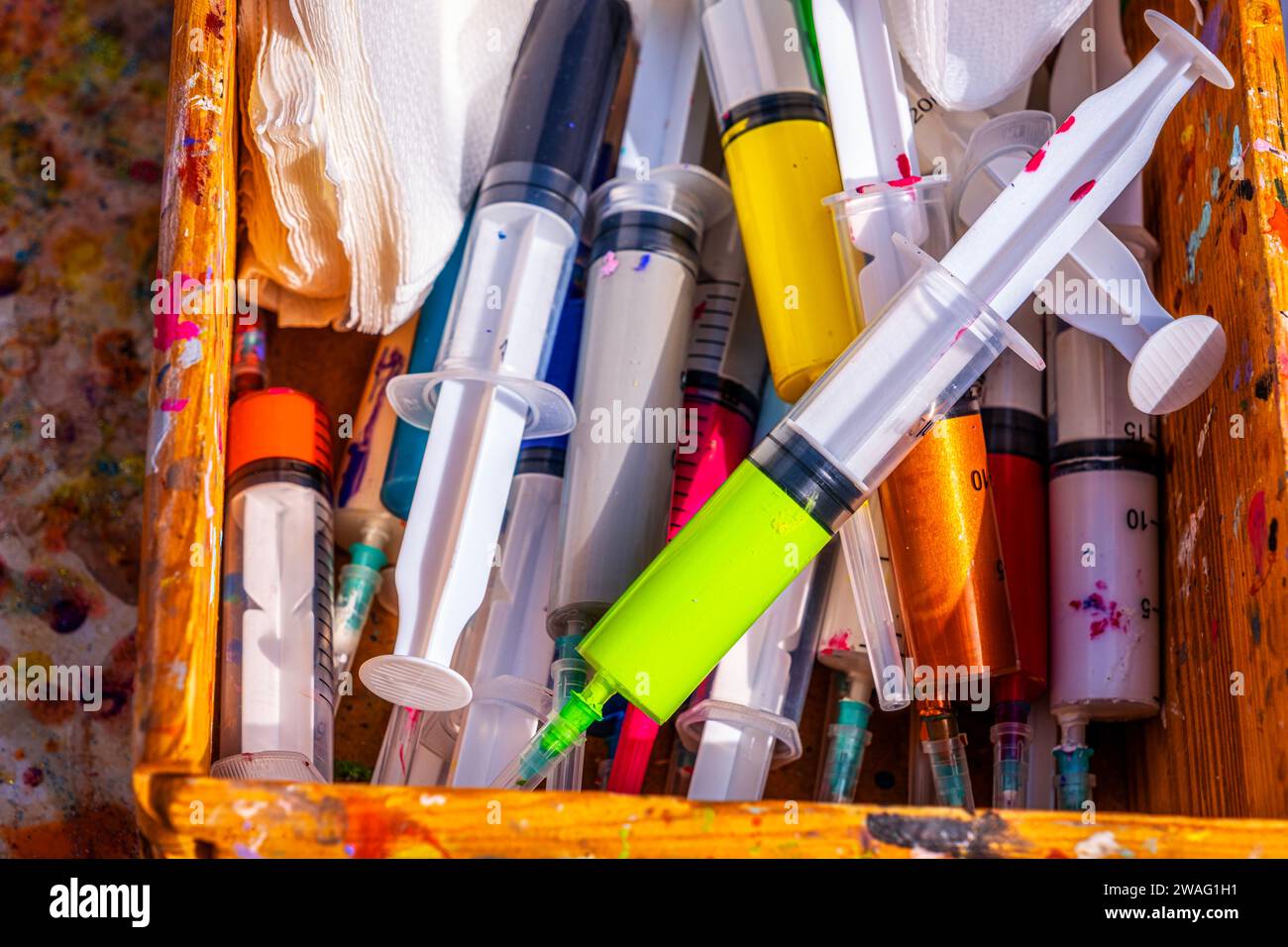 a bunch of Syringes with multi-colored liquid in the wooden box Stock ...