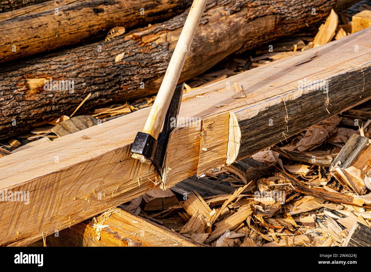 an ax for chopping wood is stuck in a log Stock Photo - Alamy