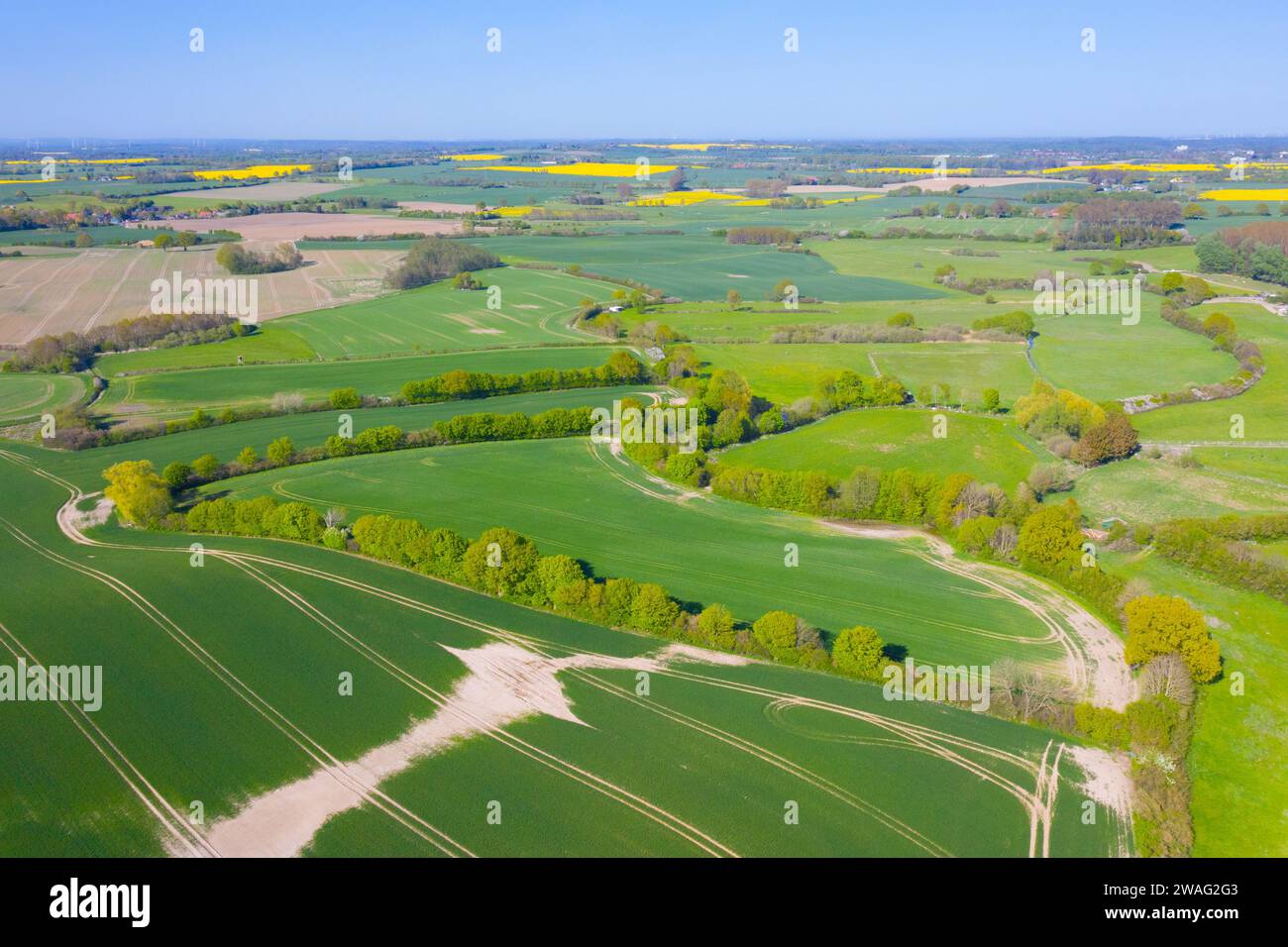 Aerial view over rural bocage landscape with fields and pastures ...
