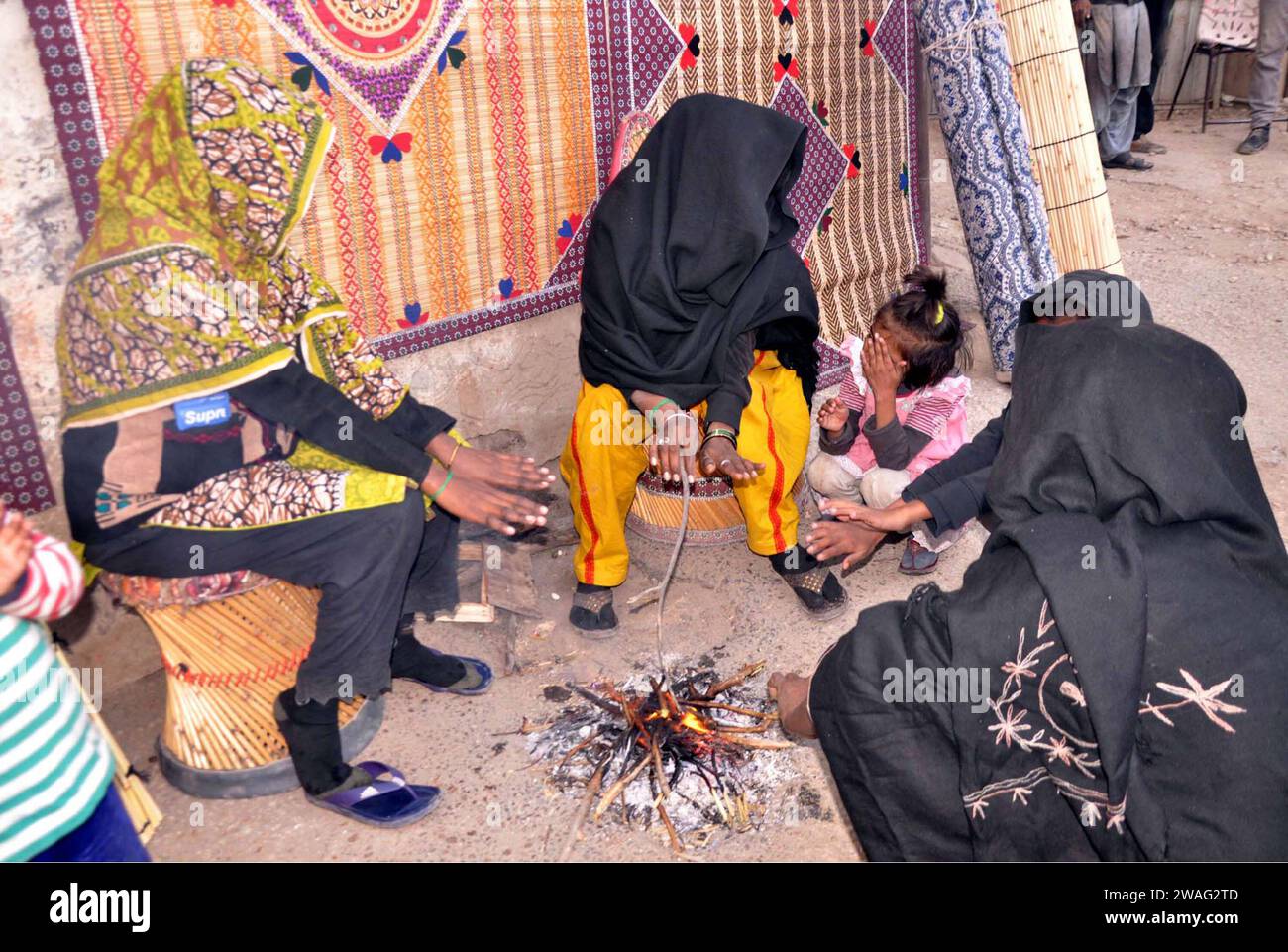 People warm their hands on bone-fire to save themselves from cold waves ...