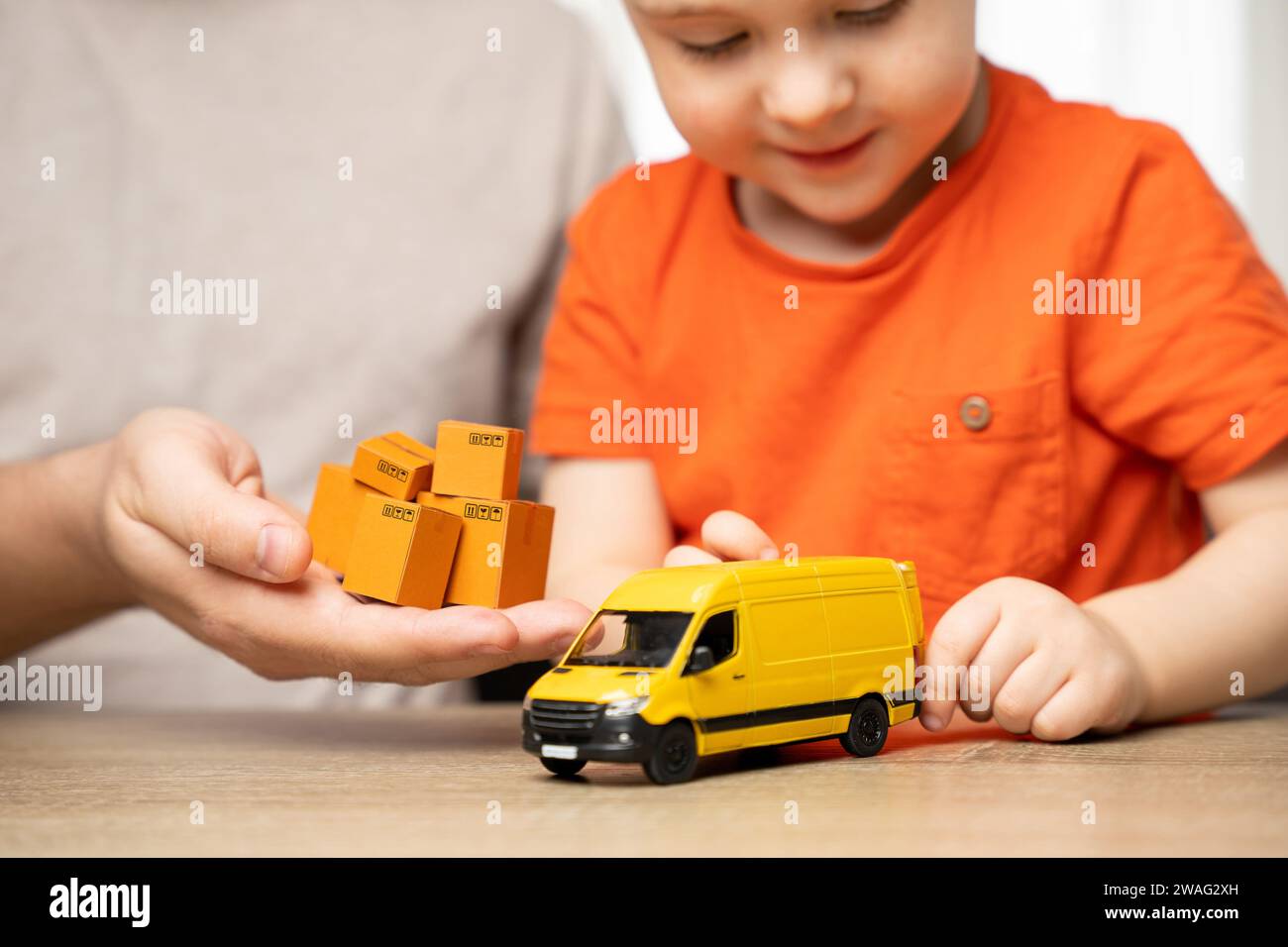 The father shows the boy how delivery of orders works. Home business ...