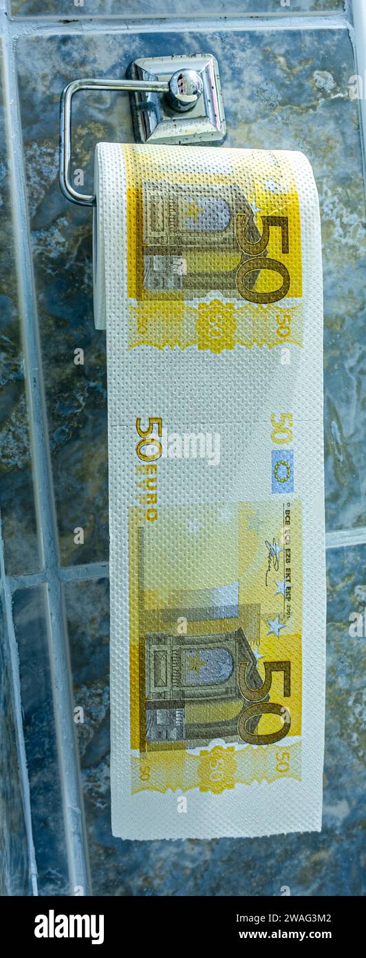 Roll of money bank notes toilet paper in bathroom Stock Photo - Alamy
