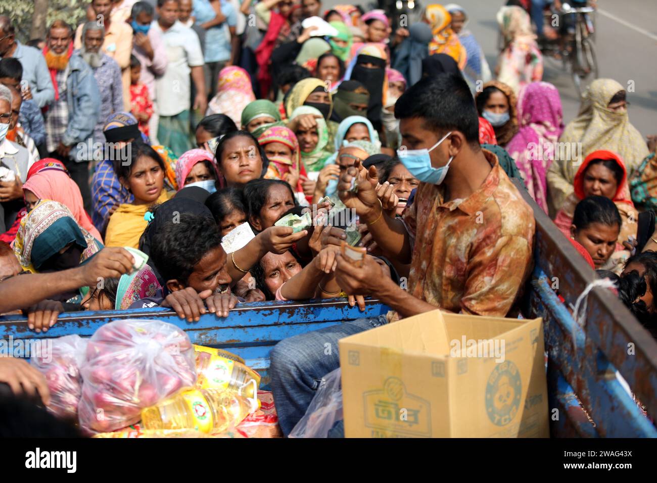 Dhaka, Wari, Bangladesh. 4th Jan, 2024. People wait in a line to buy ...