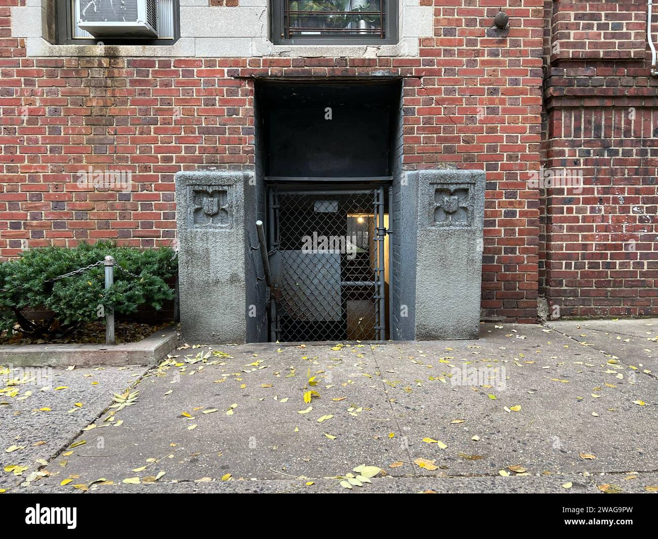 A red brick building with a metal doorway Stock Photo - Alamy