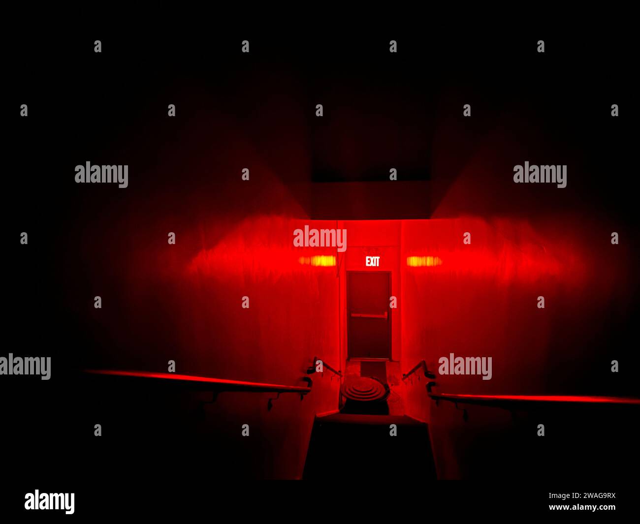 An interior shot of a dark room illuminated by red light and a glowing ...
