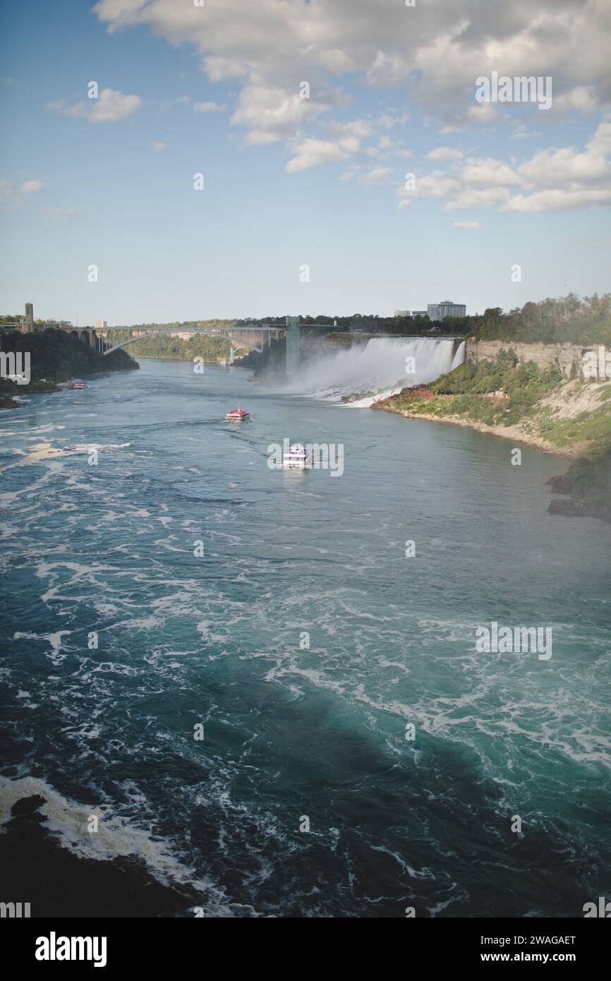 The boats traveling along the river with Niagara Falls in the ...