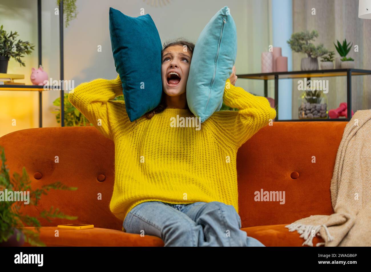 Repair work at neighbors. Irritated child girl kid screaming cover ears ...