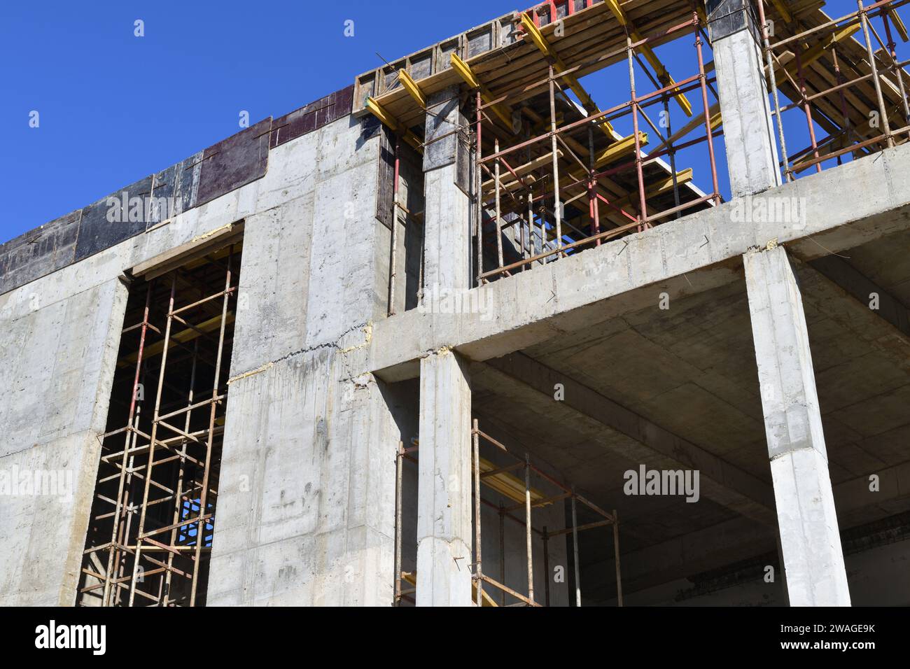 brick monolithic building under construction with wooden scaffolding ...