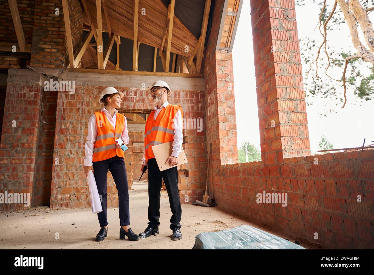 Joyous building inspector communicating with contractor during site ...