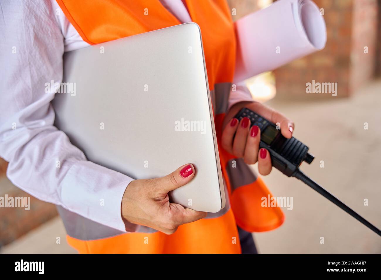 Building inspector using portable two-way radio and computer on site ...