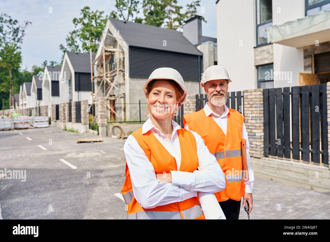 Construction supervisor and her colleague inspecting new housing ...