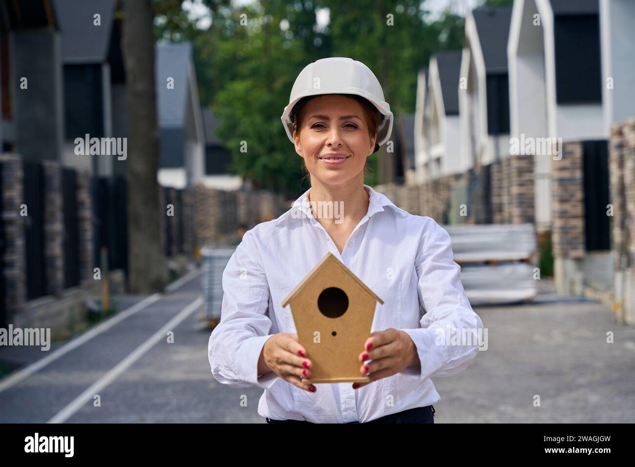 Project contractor showing assembled birdhouse in cottage development ...