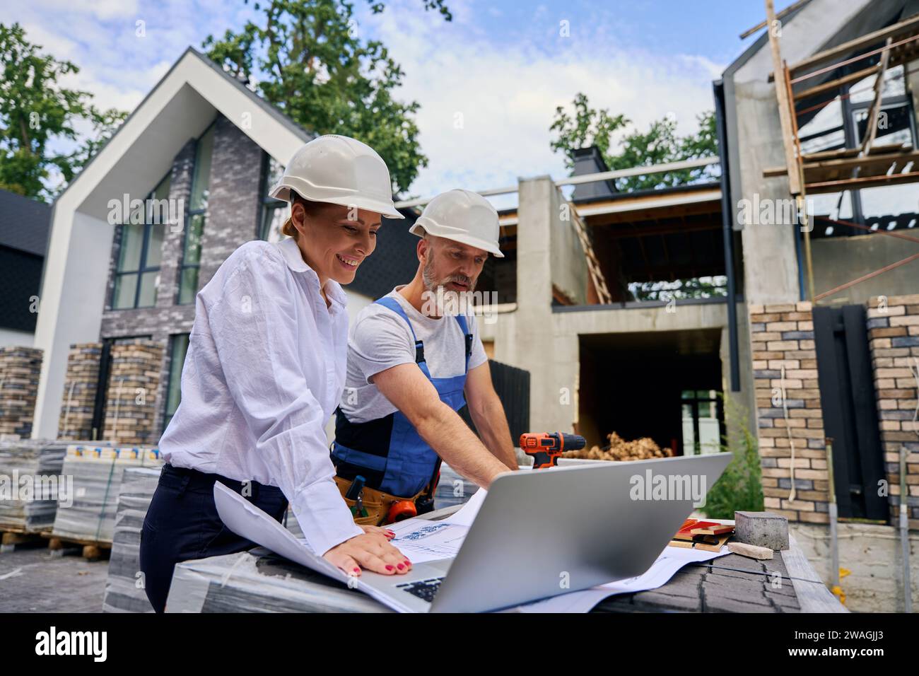 Building experts discussing new architectural drawings outdoors Stock ...