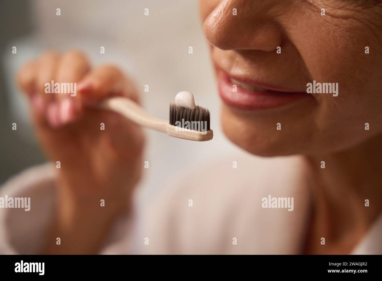 Lady brushes her teeth with a toothbrush and toothpaste Stock Photo - Alamy