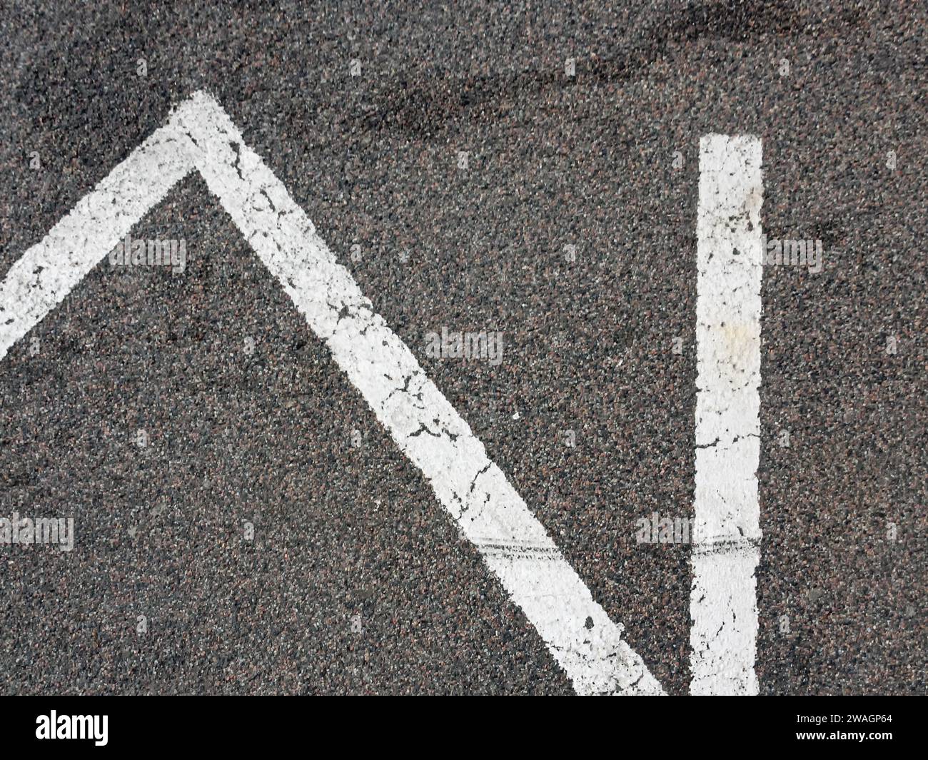 Close-up of a white, jagged marking on asphalt Stock Photo - Alamy