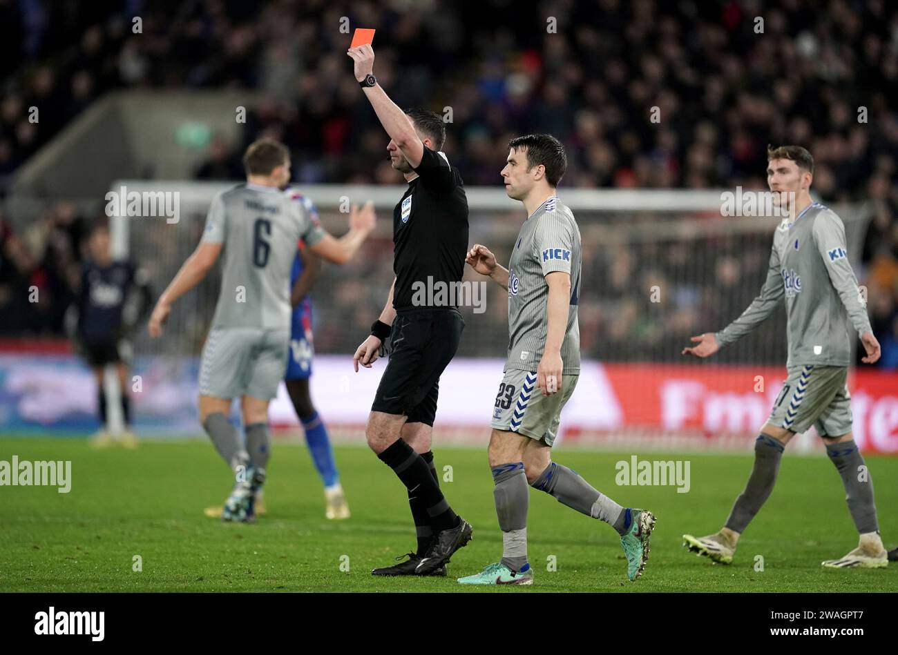 Referee Chris Kavanagh shows a red card to Everton's Dominic Calvert ...