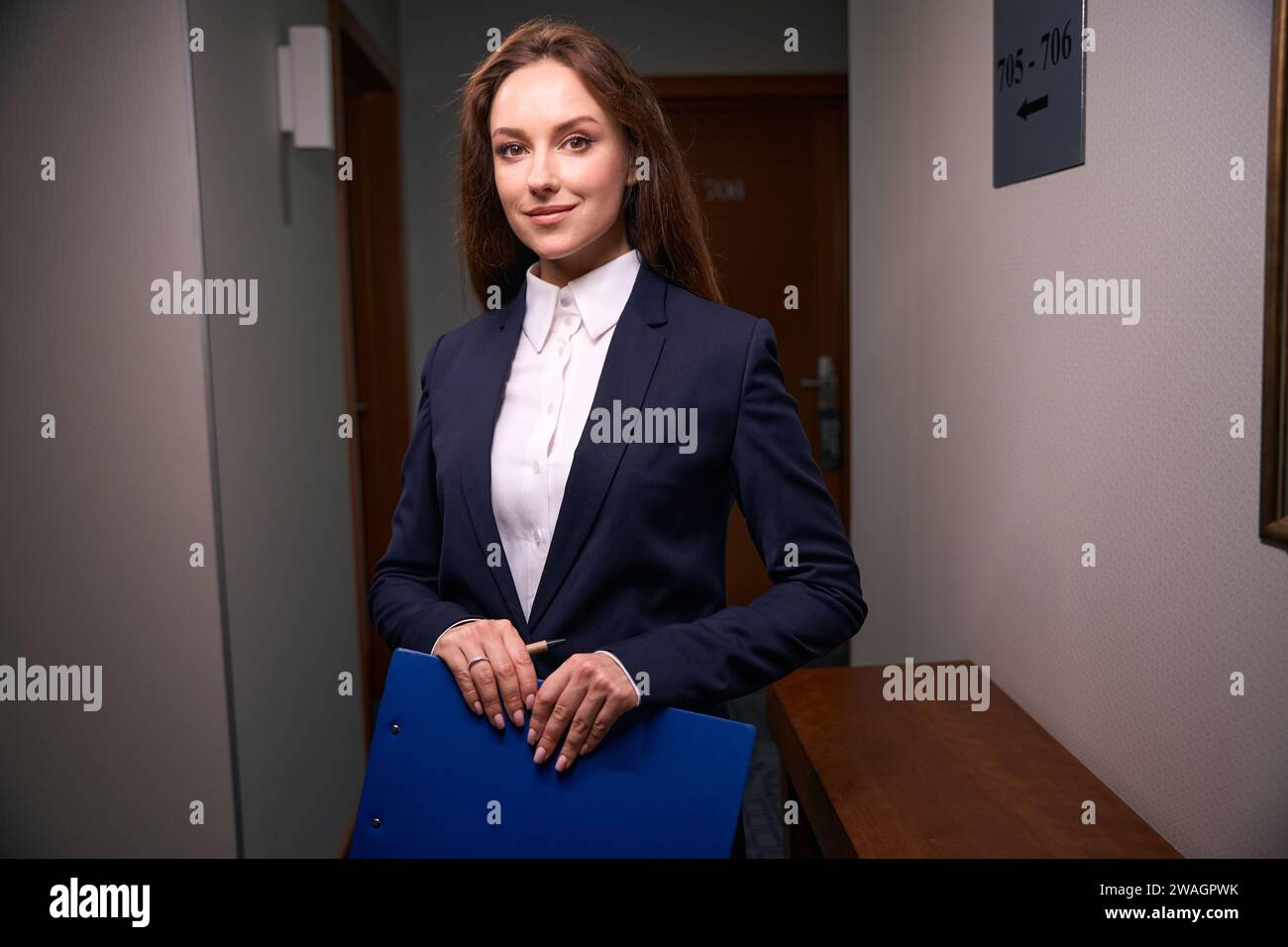 Pleased manager posing for camera before conducting room inspection ...