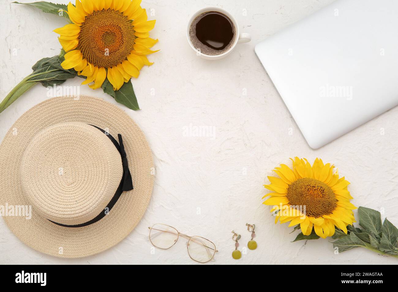 Frame made of beautiful sunflowers, accessories and modern laptop on ...