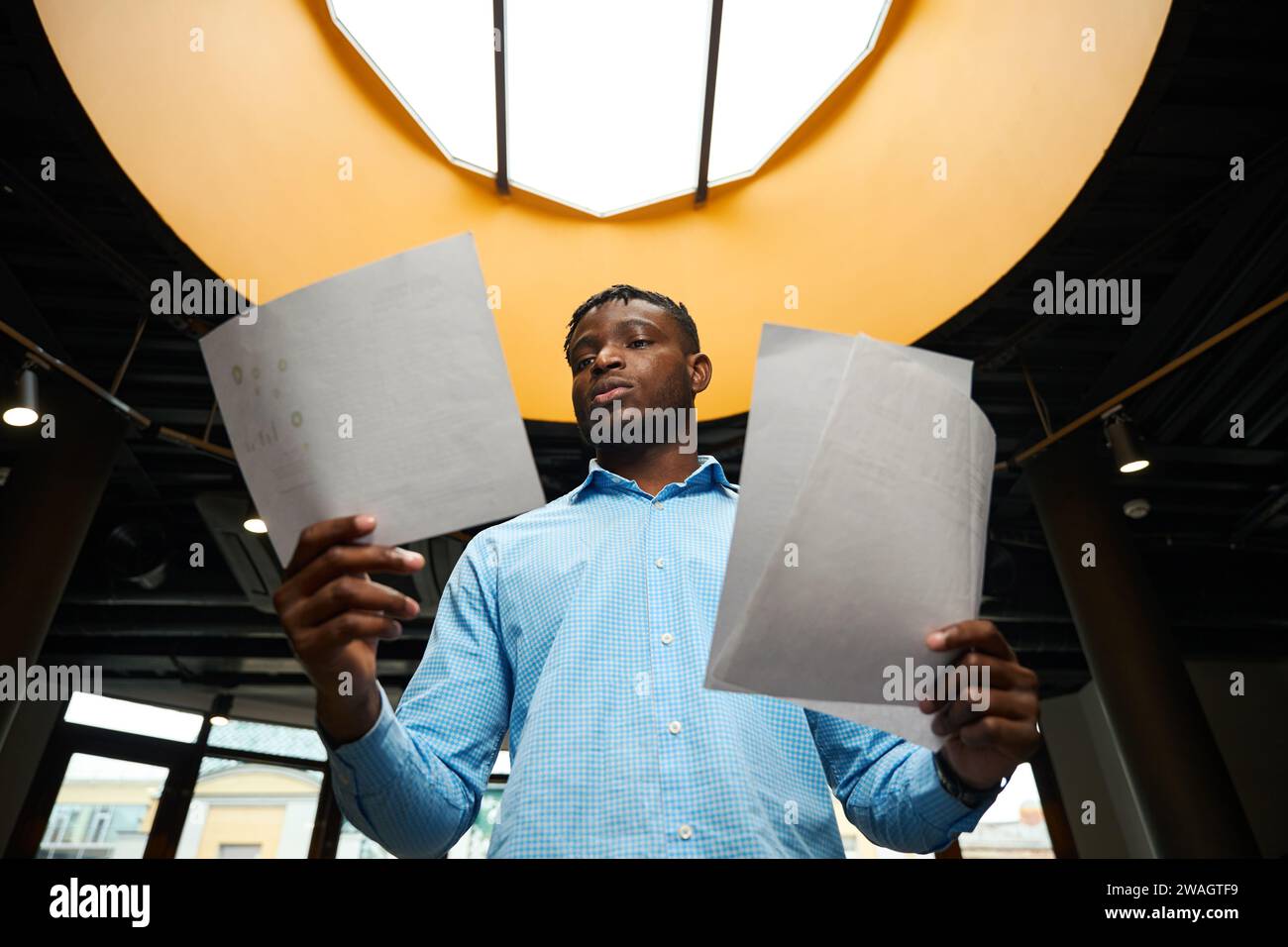 Bottom view man head manager looking through papers Stock Photo - Alamy