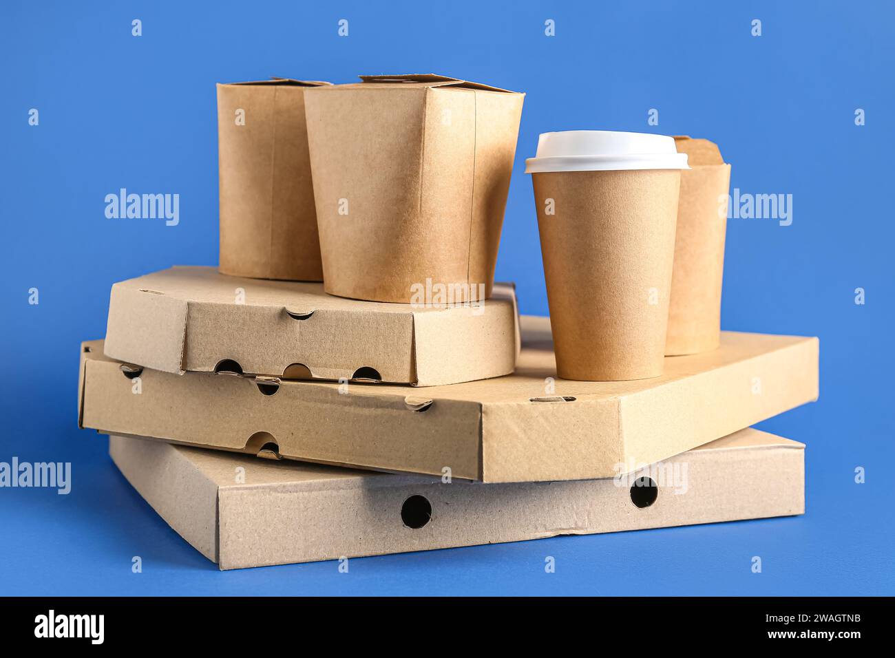 Takeaway paper cup and different boxes on blue background Stock Photo ...