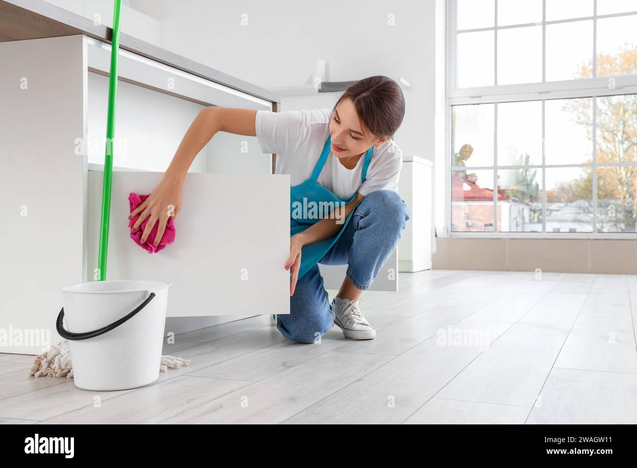 Female janitor cleaning drawer in kitchen Stock Photo - Alamy