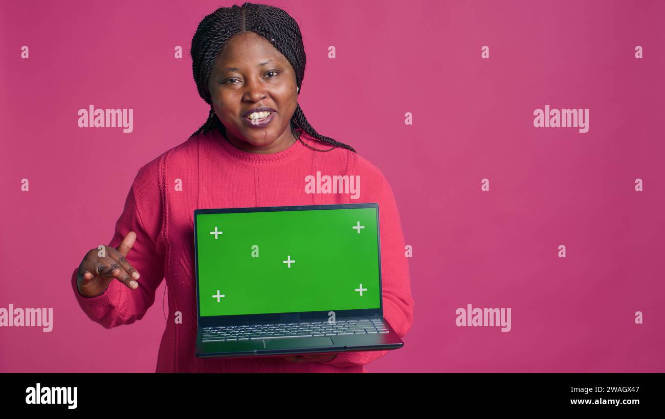 Young lady with african american ethnicity grasping laptop showcasing ...