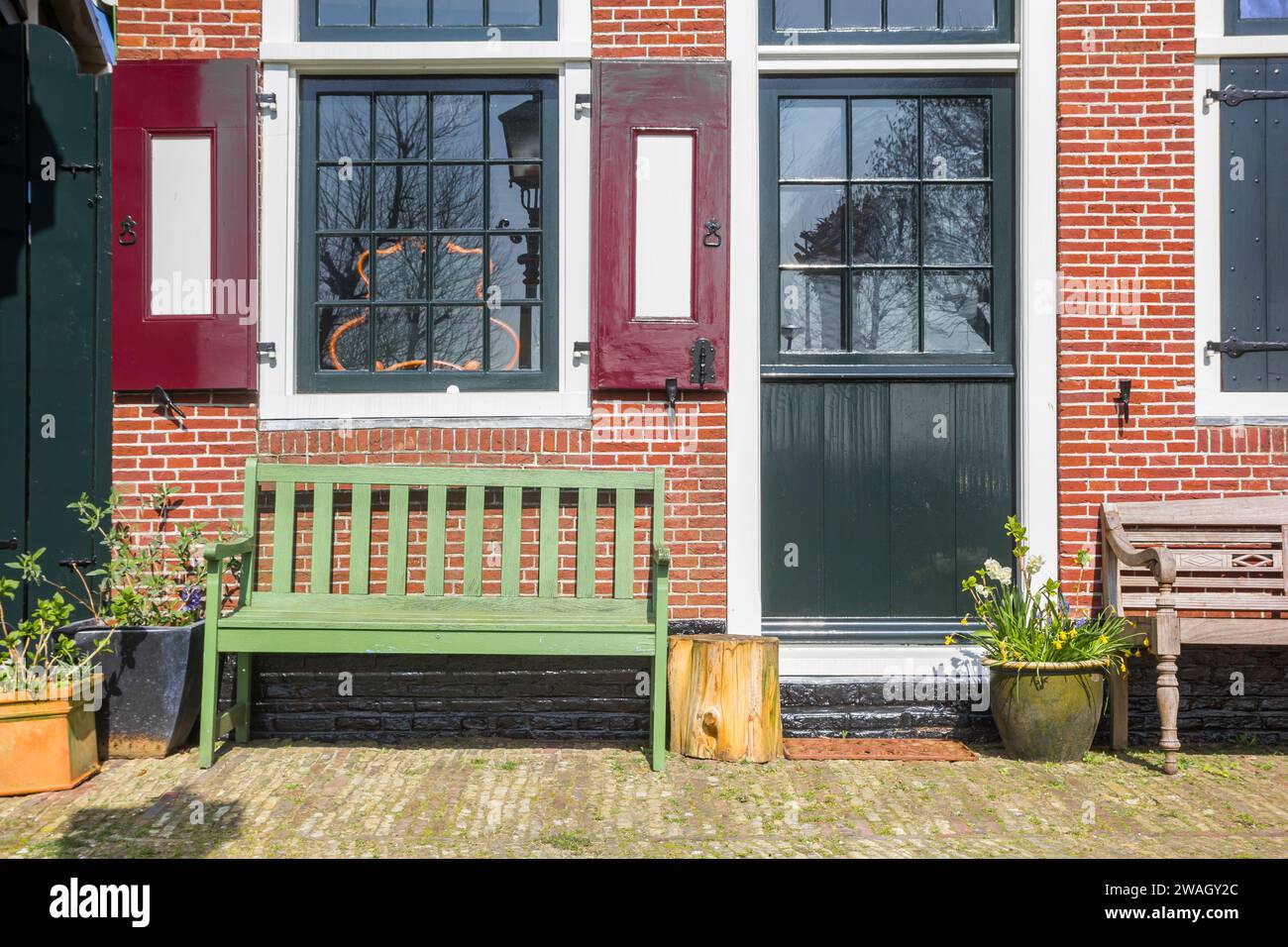 Bench in front of brick house hi-res stock photography and images - Alamy
