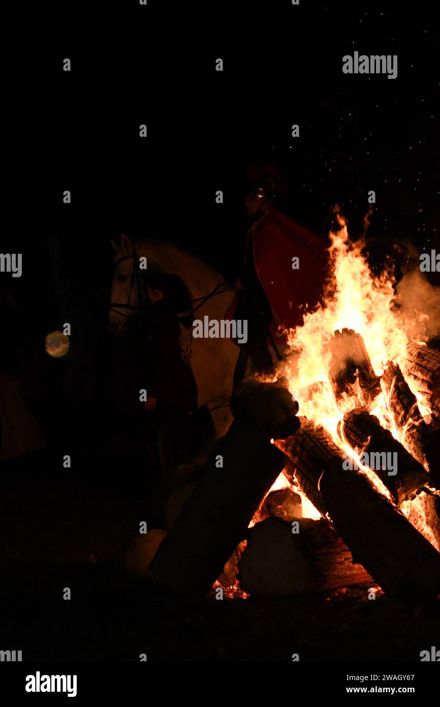 Large blazing bonfire at night with St. Martin on horseback in ...
