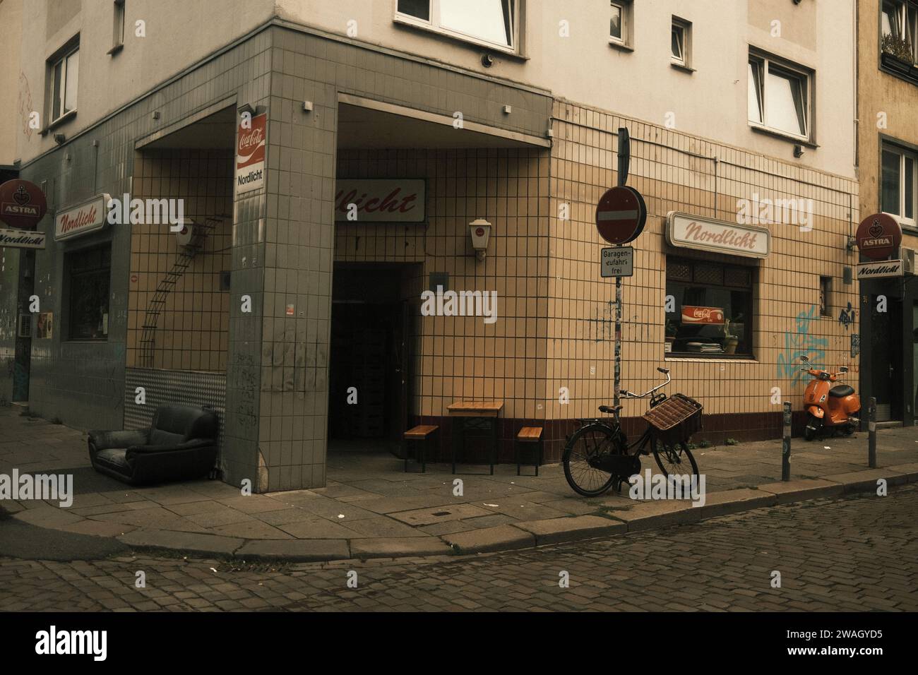 Pub on a German street with street signs and a bike parked near the ...