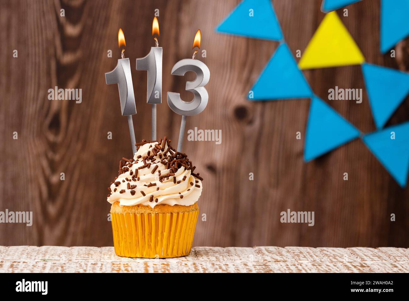 Birthday card with candle number 113 - Wooden background with pennants ...