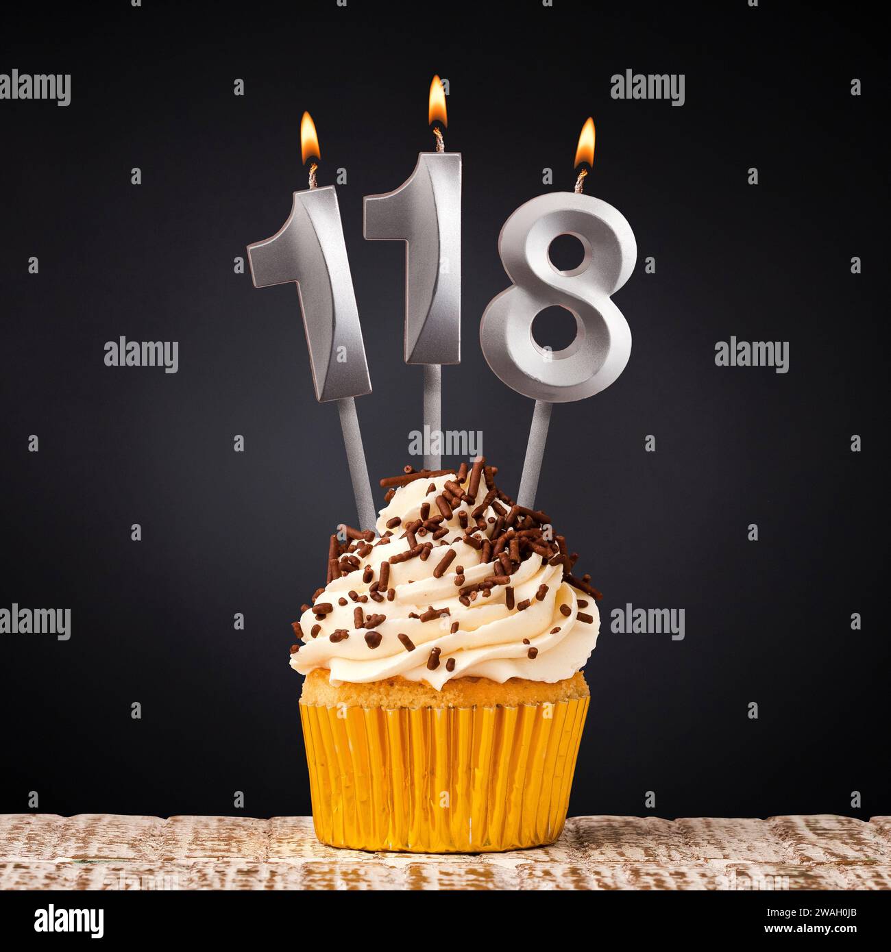 birthday cupcake with number 118 candle - Celebration on dark ...