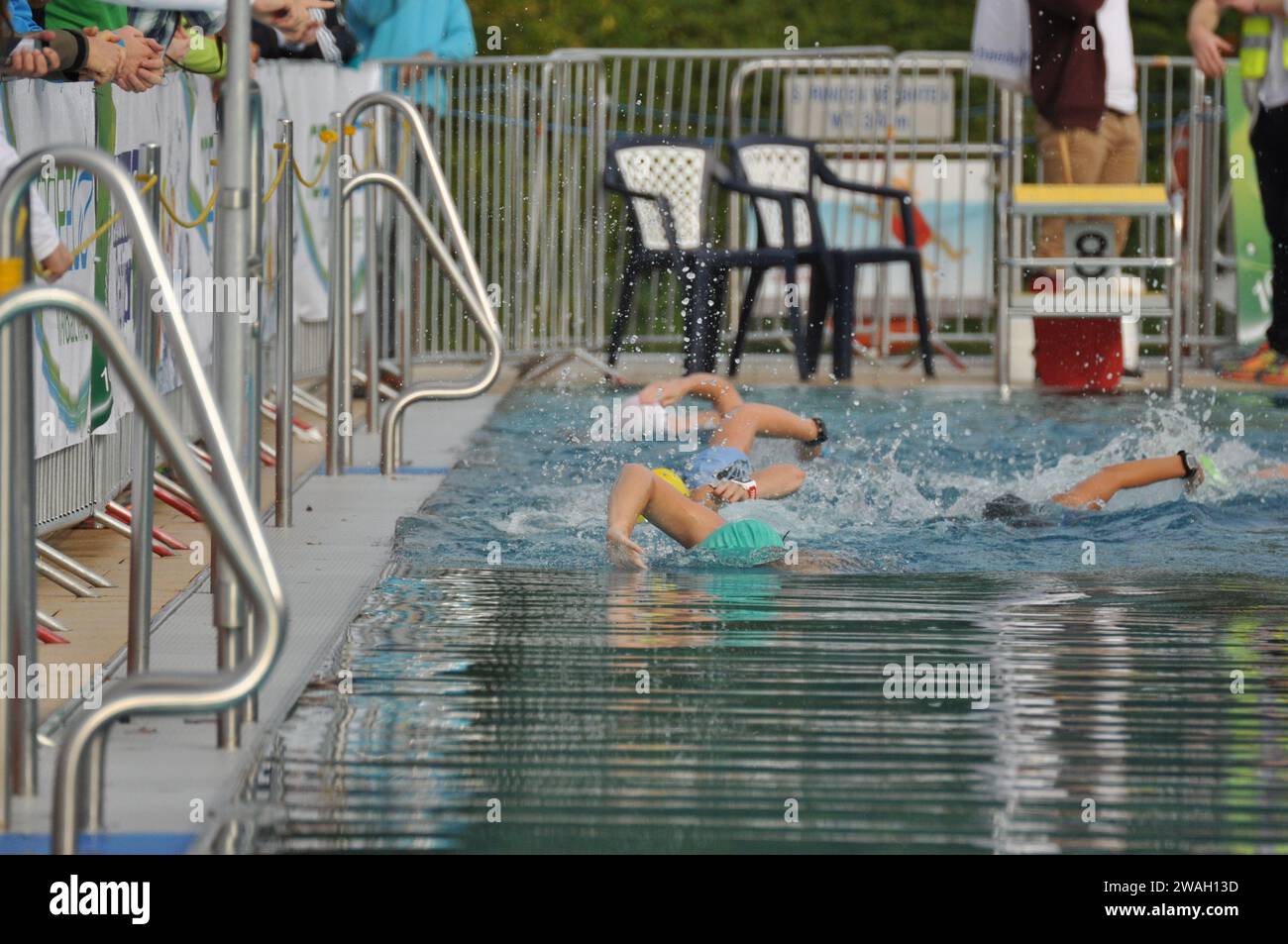 Athletes swimming in the pool during a triathlon competition in Germany ...